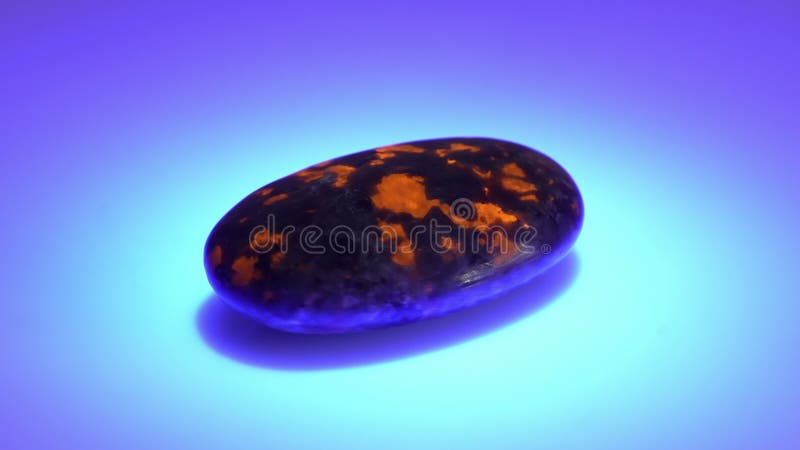 Yooperlite Specimen Rotating Under UV Light Revealing Fluorescent ...