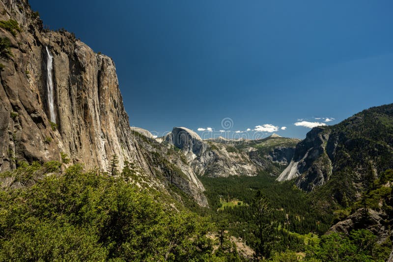 Yosemite Falls and Half Dome Tower Over Yosemite Valley Stock Photo ...