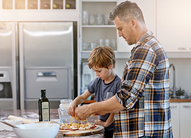 You Can Never Have Enough Cheese. a Father and His Son Making Pizza at ...