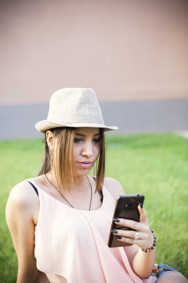 Youn girl with smart phone stock photo. Image of modern - 76756004