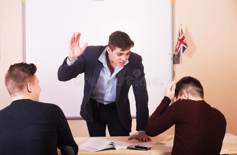 Youn Teacher Threatens the Distracted Student during the Lesson. Stock ...