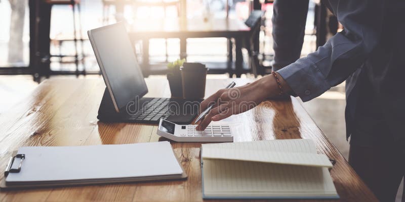 Young Accountant Man Analyzes Financial Data Using Calculator and ...