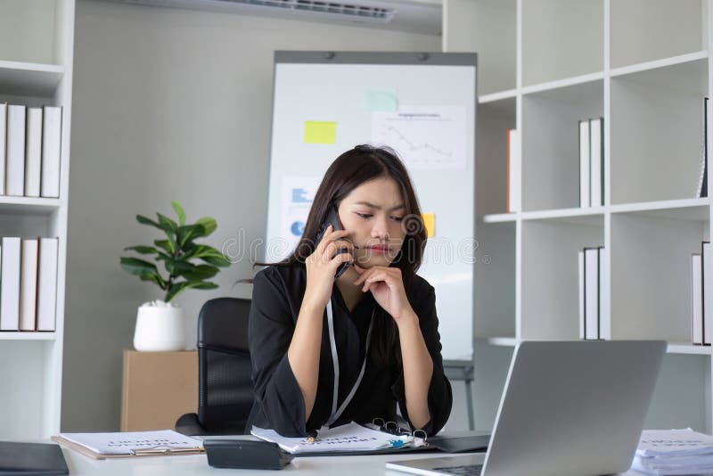 Young Accountant Using Telephone while Doing Paperwork in Modern Office ...