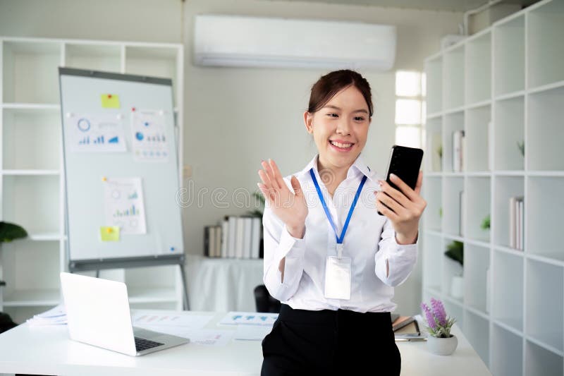 Young Accountant Using Telephone while Doing Paperwork in Modern Office ...