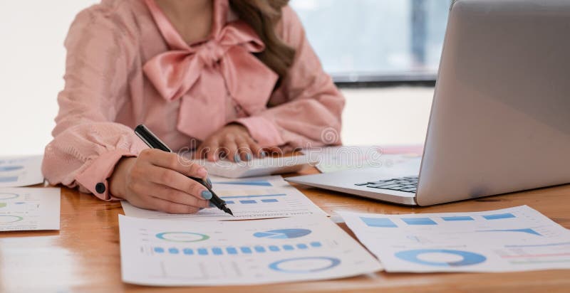 Young Accountant Analyzing Financial Documents at Desk with Laptop in ...