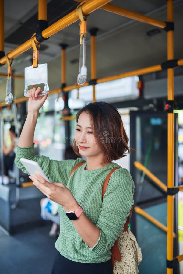 Young Adorable Joyful Woman is Standing on the Bus Using the Phone and ...