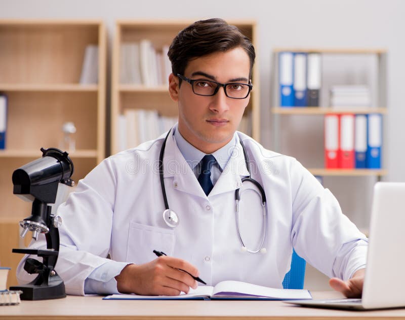Young Adult Doctor with Laptop Computer Stock Image - Image of hospital ...
