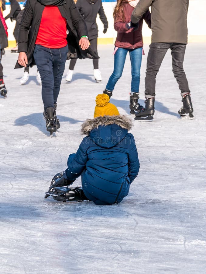 Young Adult on Ice Skates Falling on the Ice Rink Stock Photo - Image ...
