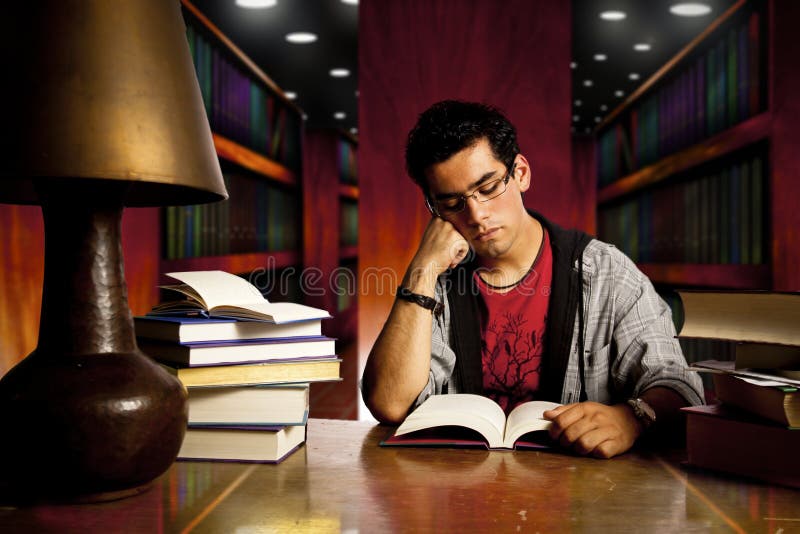 Young Adult Student Reads Book at Library Stock Image - Image of ...