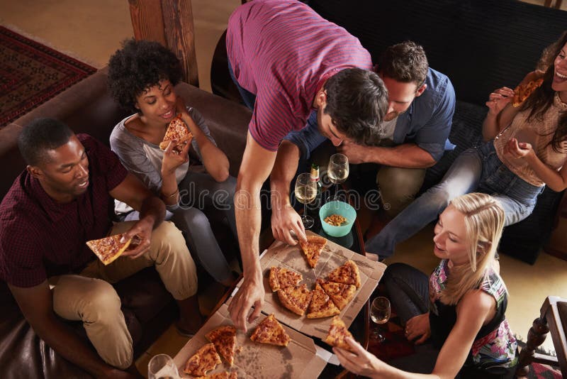 Young Adults Eating Pizzas at a Party at Home, Elevated View Stock ...