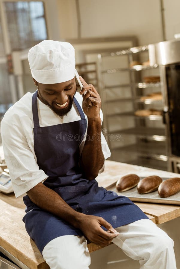 Young African American Baker with Hands Covered in Flour Talking by ...