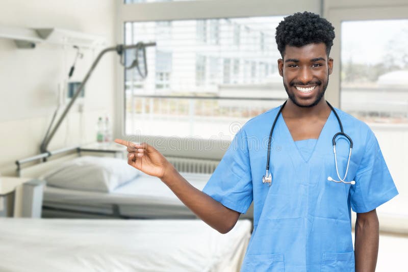 Young African American Doctor or Male Nurse Pointing Sideways at ... Young African American Doctor or Male Nurse Pointing Sideways at ...