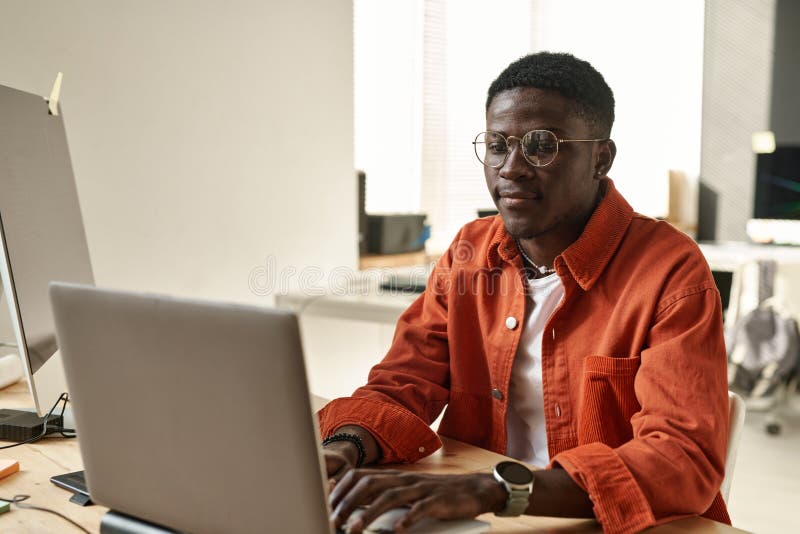 Young African American it Engineer or Webdesigner Looking at Laptop ...