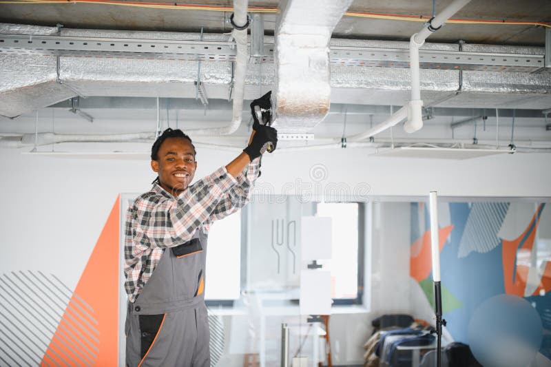 Hvac Technician Installing Air Conditioning System in Modern Office ...