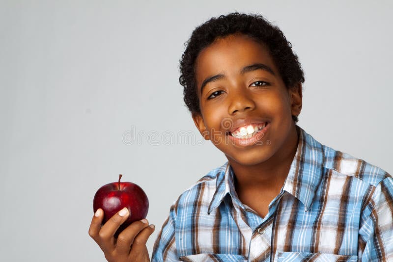 Young African American Kid Eating an Apple Isolated on White. Stock ...
