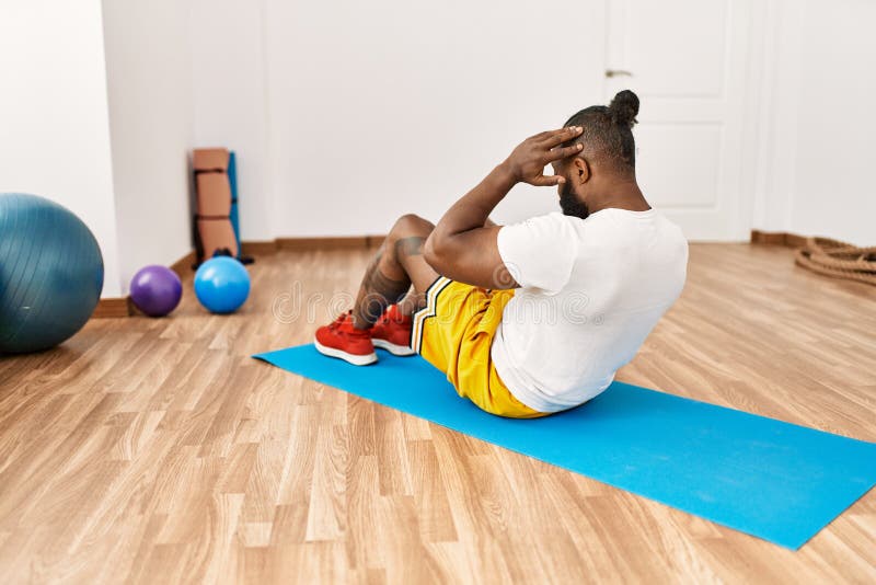 Young African American Man on Back View Training Abs Exercise at Sport ...