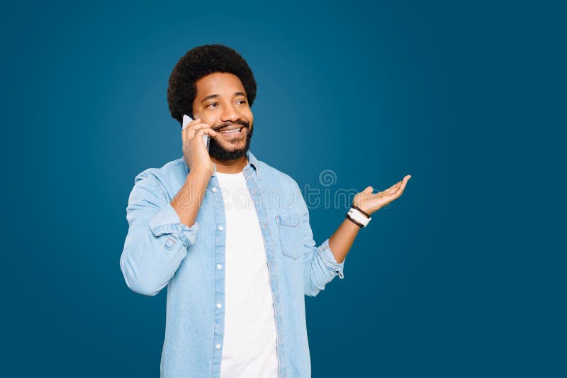 A Young African-American Man is Engaged in a Phone Call Stock Photo ...