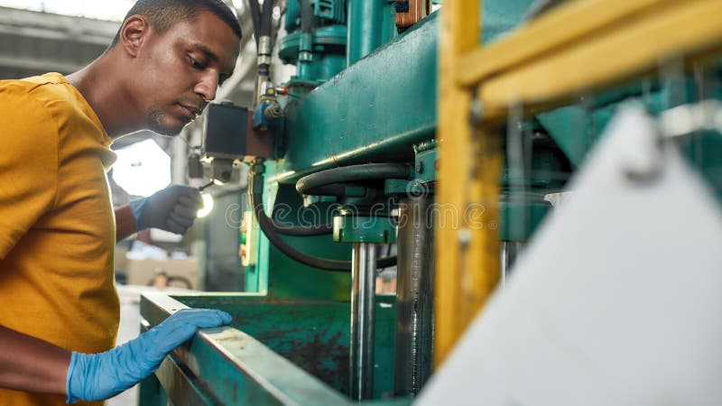 Young African American Man Operating Compression Machine Stock Photo ...