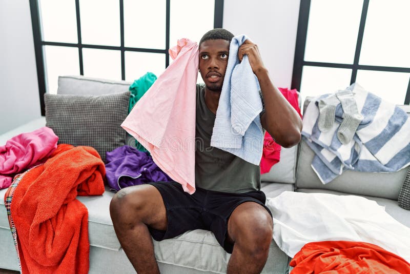 Young African American Man Stressed for Clothes Disorder at Home Stock ...