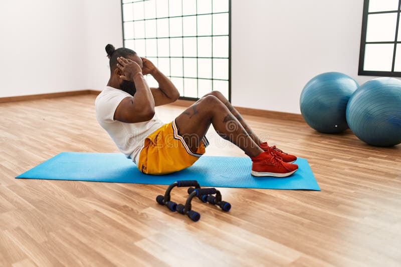 Young African American Man Training Abs Exercise at Sport Center Stock ...