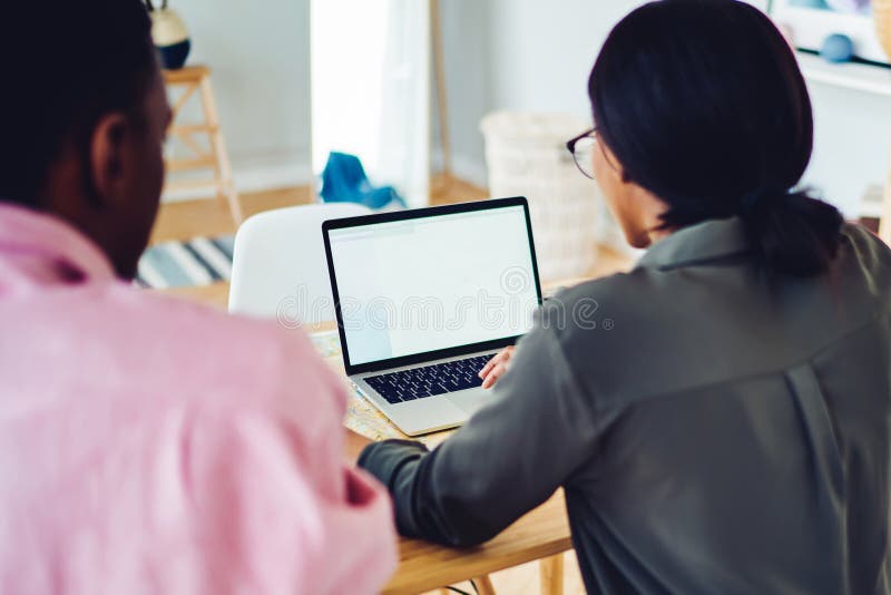 Young African American Students Cooperating on Homework Project Sitting ...