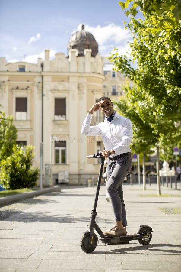 Young African American Using Electric Scooter on a Street Stock Image ...