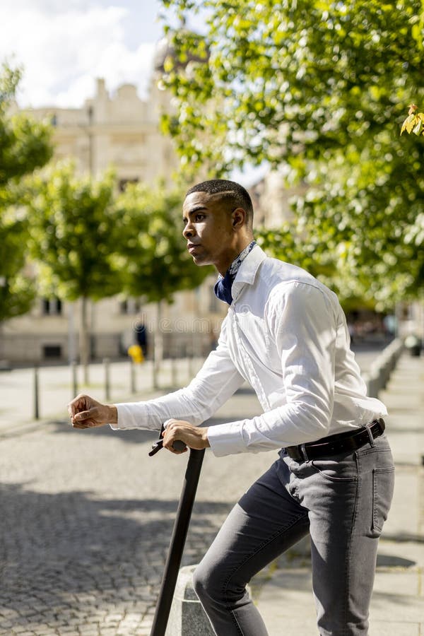 Young African American Using Electric Scooter on a Street Stock Image ...