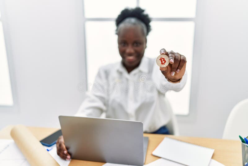 Young African American Woman Architect Using Laptop Holding Bitcoin at ...