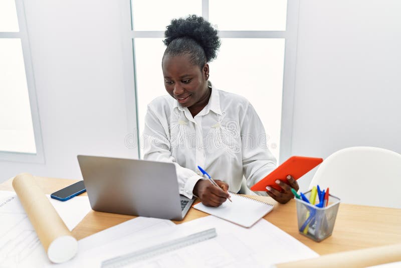 Young African American Woman Architect Using Touchpad Writing on ...