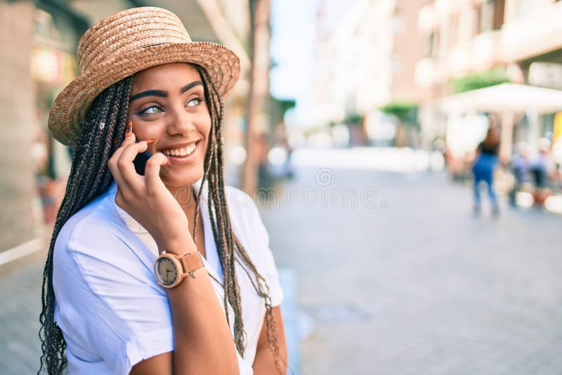 Young African American Woman with Braids Smiling Happy Outdoors on a ... Young African American Woman with Braids Smiling Happy Outdoors on a ...