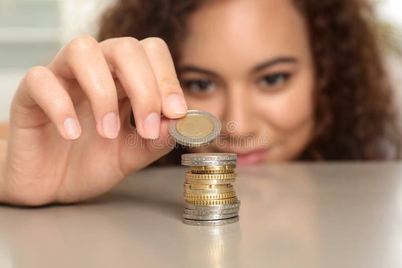 Young African-American Woman Stacking Coins, Focus on Hand Stock Photo ...