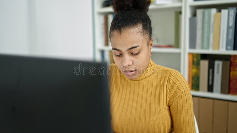 Young African American Woman Student Using Computer Studying at the ...