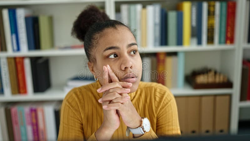 Young African American Woman Student Using Computer Thinking at the ...
