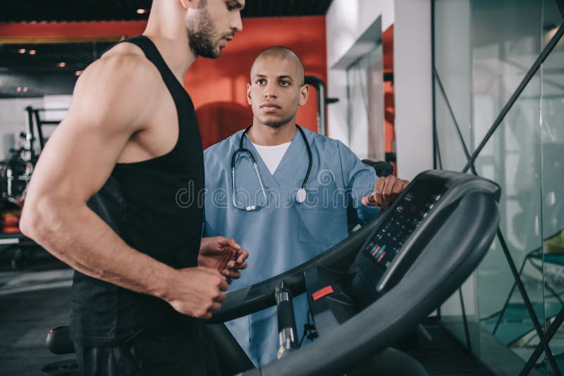 Young African Ameriican Doctor Supervising Sportsman Stock Image ...