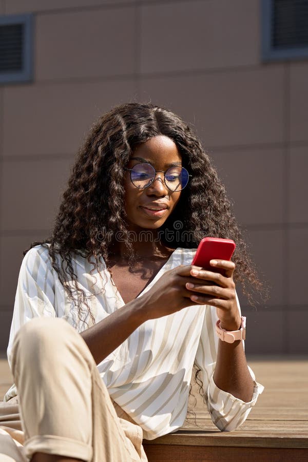 Young African Black Woman Model Using Mobile Cell Phone Outdoors. Stock ...