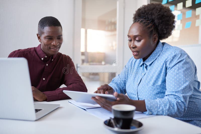 Young African Businesspeople Using Technology Together in an Office ...