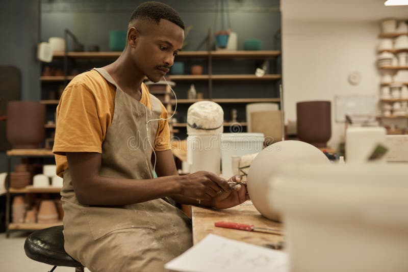 African Potter Doing Inventory Using a Tablet in a Ceramics Workshop ...