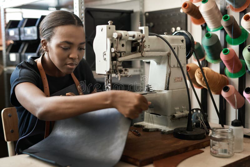 Young African Female Artisan Sewing Leather in Her Workshop Stock Image ...