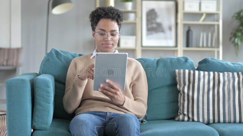 The Young African Girl is Scrolling Her Tablet Stock Photo - Image of ...