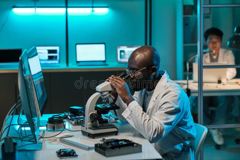 Young African Laboratory Worker Looking in Microscope Stock Image ...