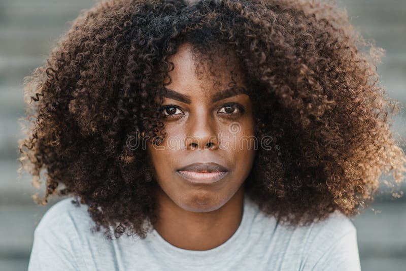 Young African Looking at Camera Outdoor in the City - Focus on Face ...