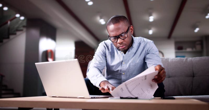 Young African Man Calculating Invoice Stock Image - Image of checks ...