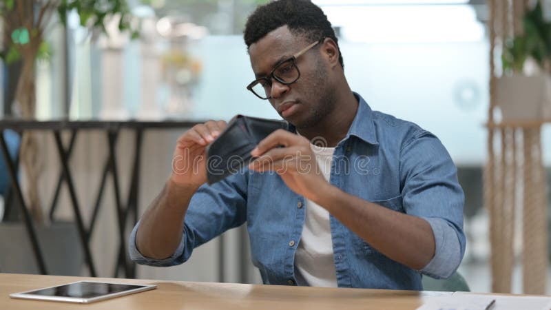 African Man Checking Empty Wallet while Sitting in Office Stock Photo ...