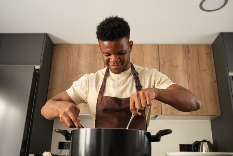 Young African Cooking in a Big Pot. Stock Image - Image of cook, candid ...