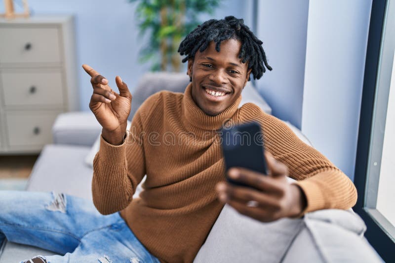 Young African Man with Dreadlocks Using Smartphone Doing Video Call ...