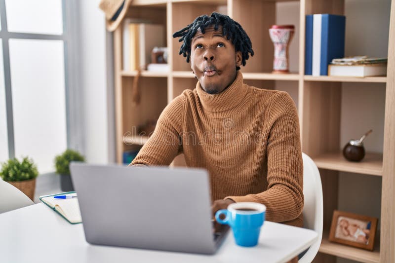 Young African Man with Dreadlocks Working Using Computer Laptop Making ...