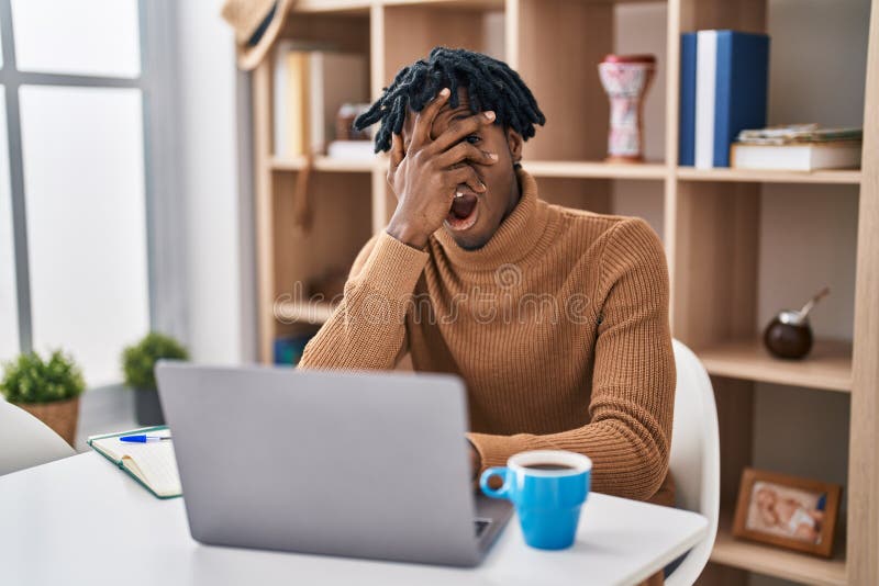 Young African Man with Dreadlocks Working Using Computer Laptop Peeking ...