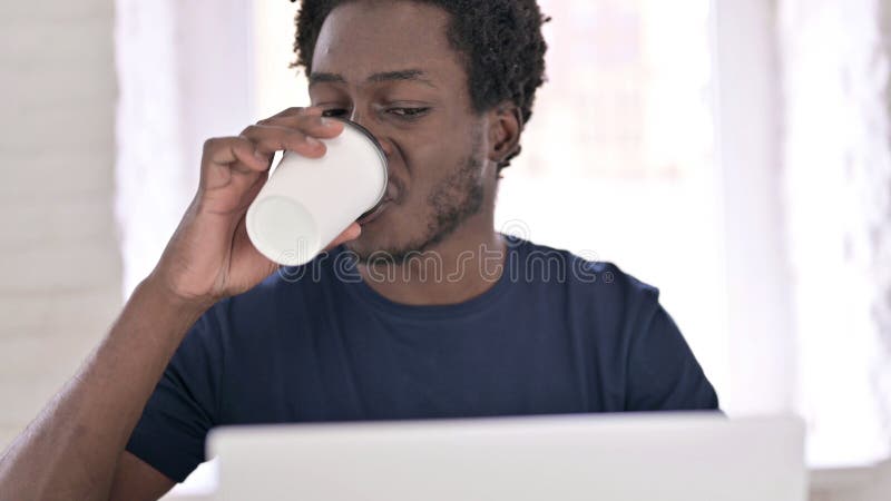 Young African Man Drinking Coffee at Work Stock Image - Image of afro ...