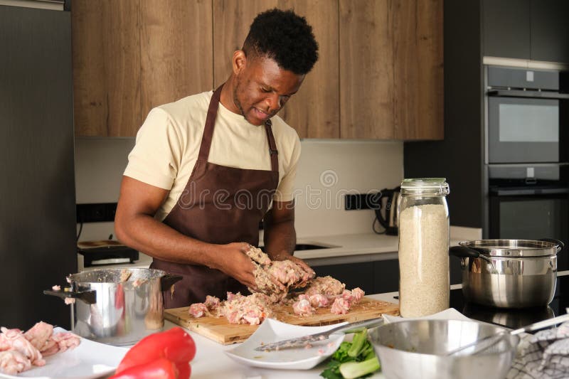 Young African Man Preparing a Chicken Mince Recipe. Stock Photo - Image ...
