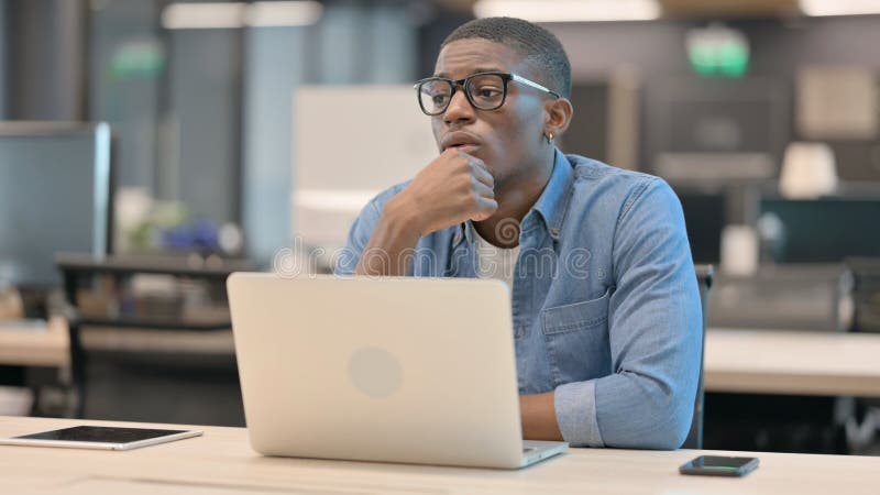 Young African Man Thinking at Work Stock Photo - Image of laptop ...